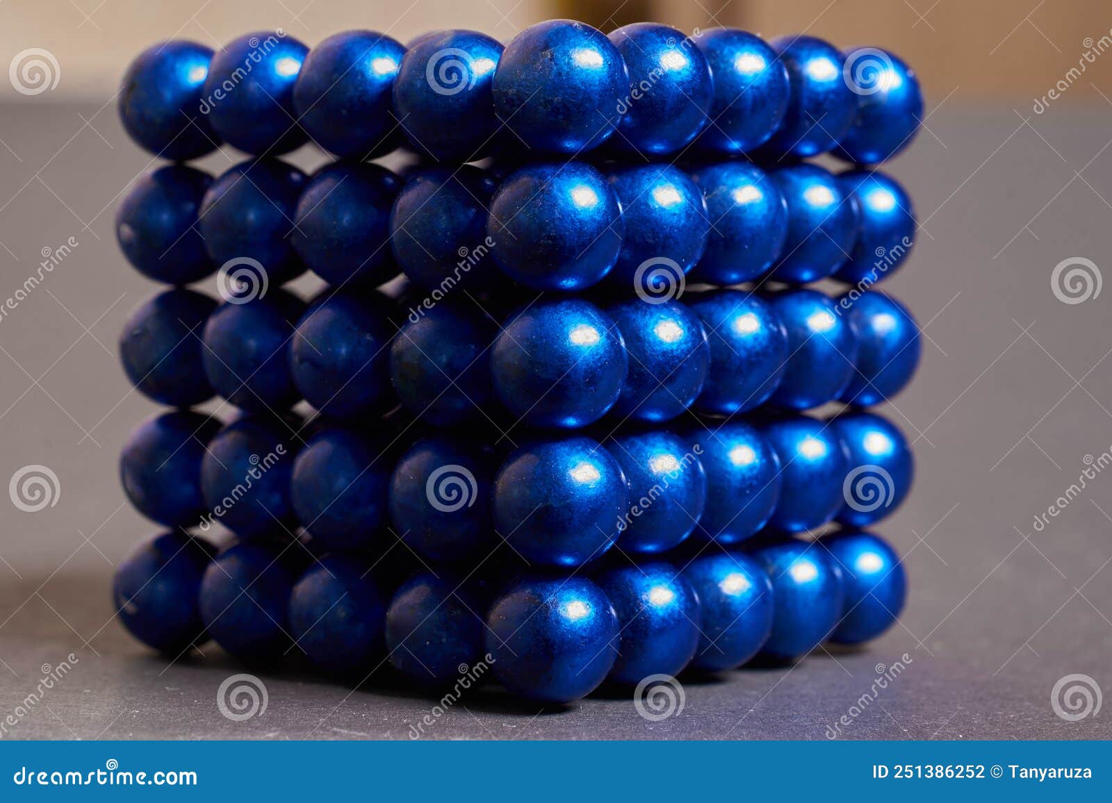 Magnetic Cube Made of Blue Metal Balls on a Colored Background Stock ...
