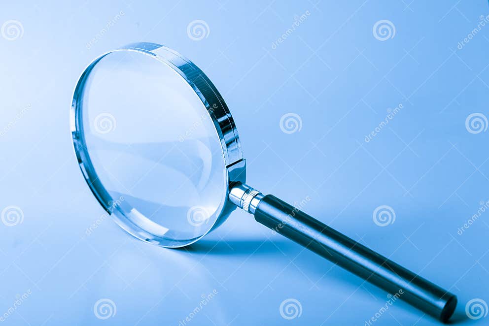 Magnifier on blue stock photo. Image of large, lens, optical - 26624616