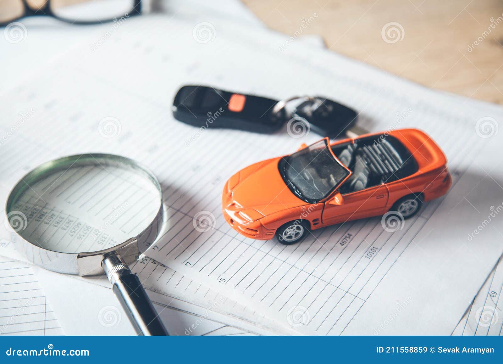 Magnifier with Key and Car Model on Document. Stock Image - Image of ...