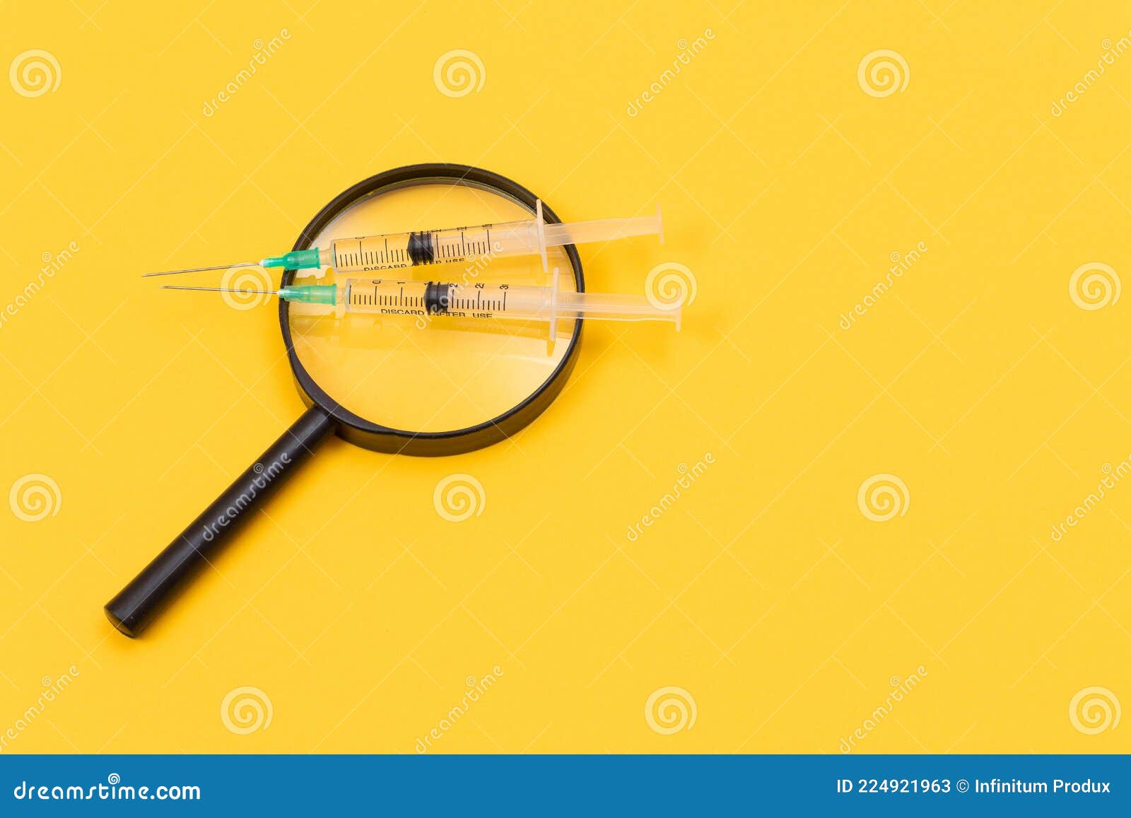 A Magnifier with Medical Syringe on Yellow Table Stock Image - Image of ...
