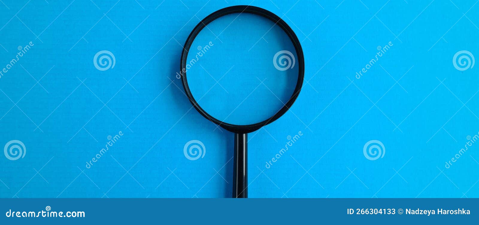 Magnifying Glass on a Blue Background Closeup Stock Image - Image of ...
