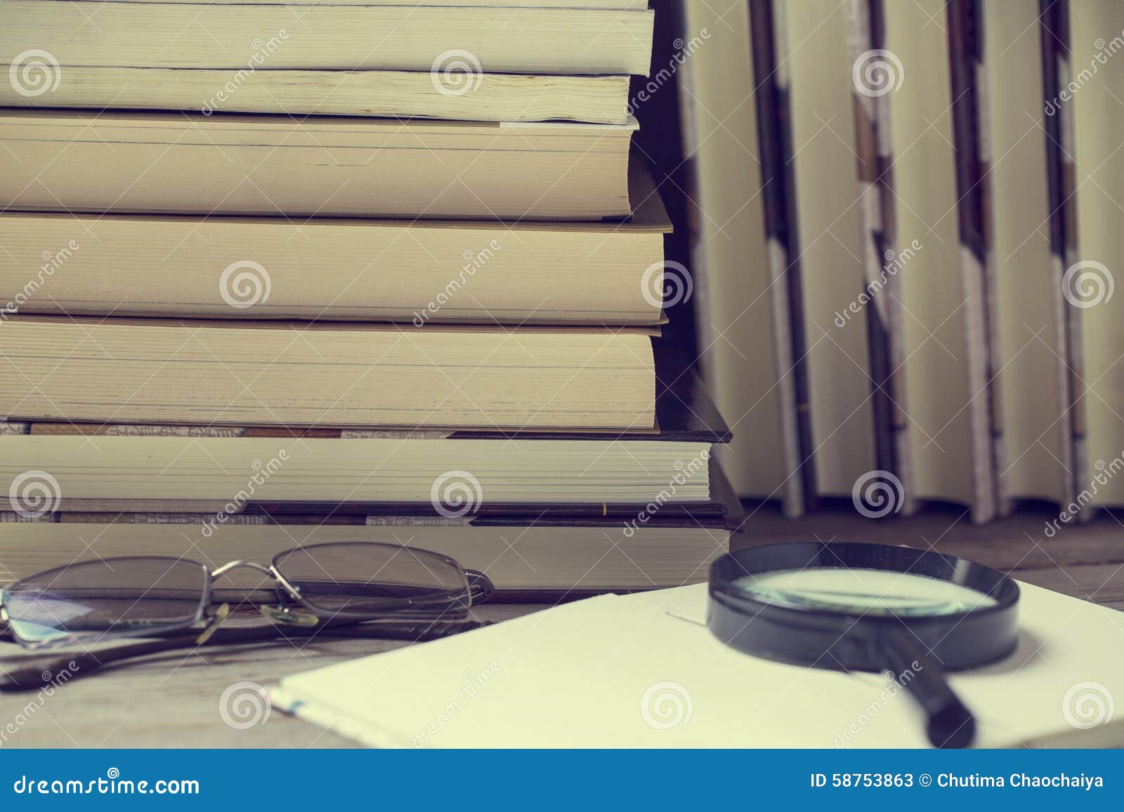Magnifying Glass and Books on Table Stock Image - Image of magnifying ...