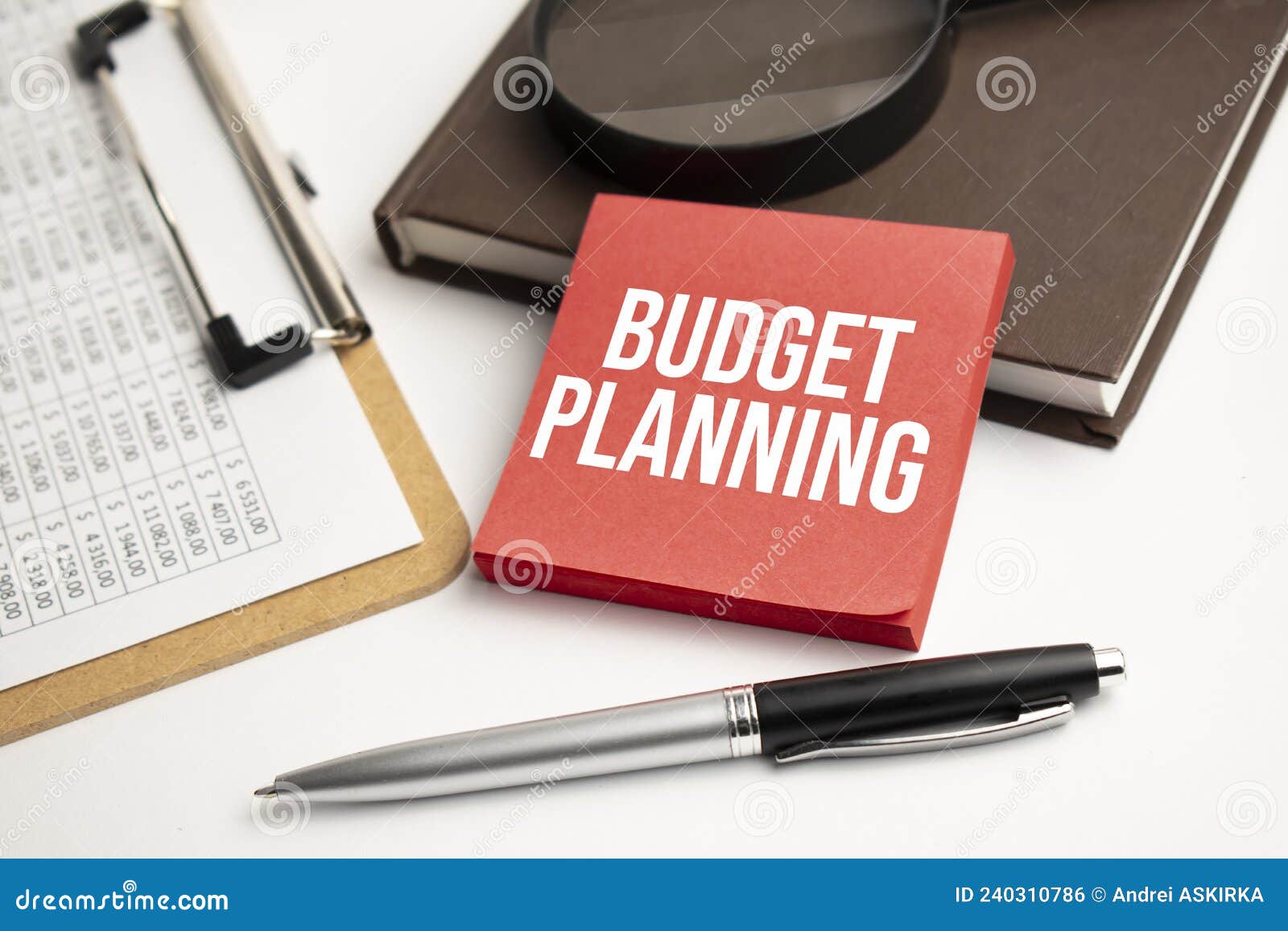 Magnifying Glass with BUDGET PLANNING on the Paper Sheet and Pen Stock ...
