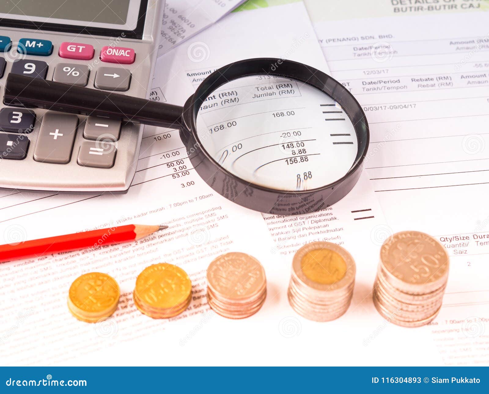 Magnifying Glass on Financial Statement with Calculator and Stack of ...