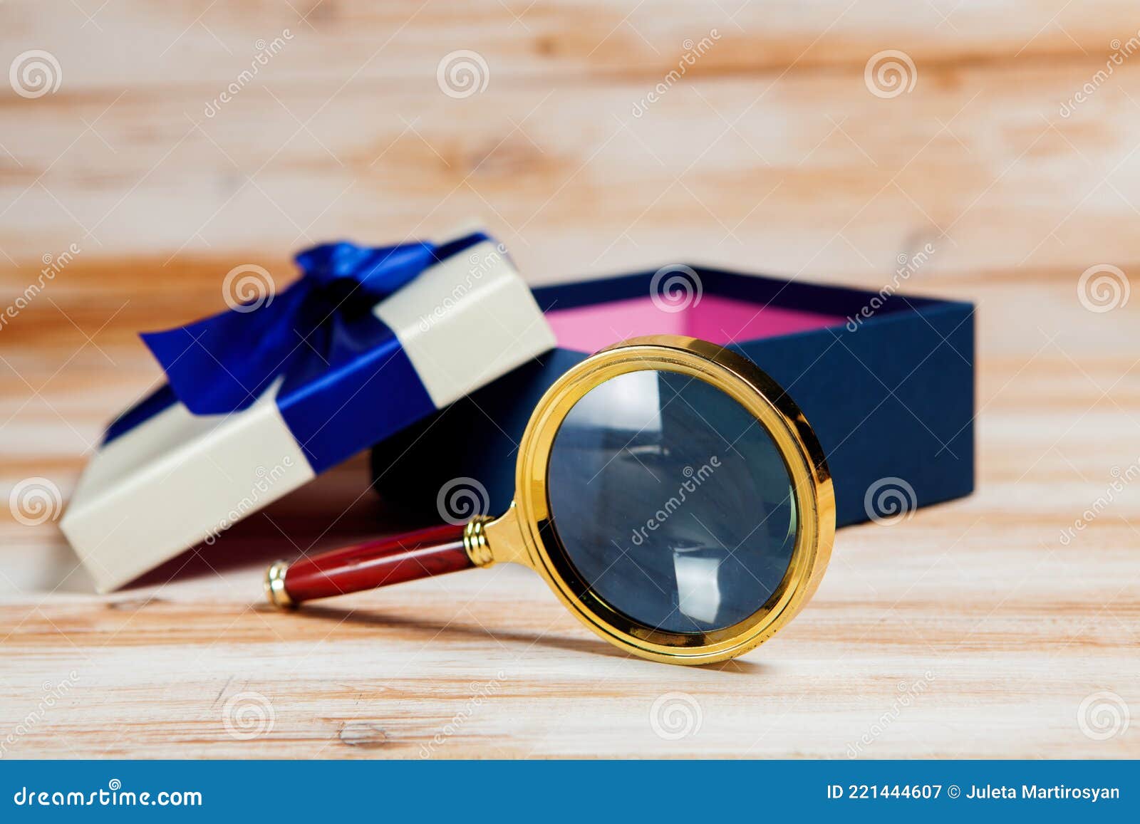 Magnifying Glass and a Gift Stock Image - Image of table, glass: 221444607