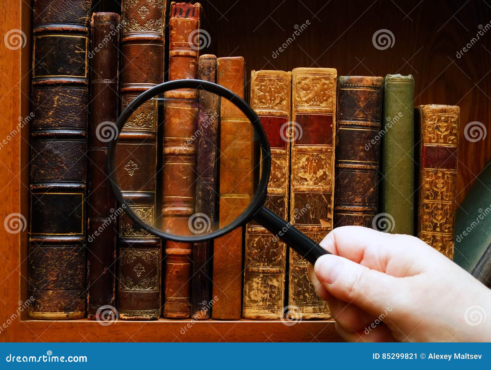 Magnifying Glass in Hand and Old Books Stock Image - Image of ...
