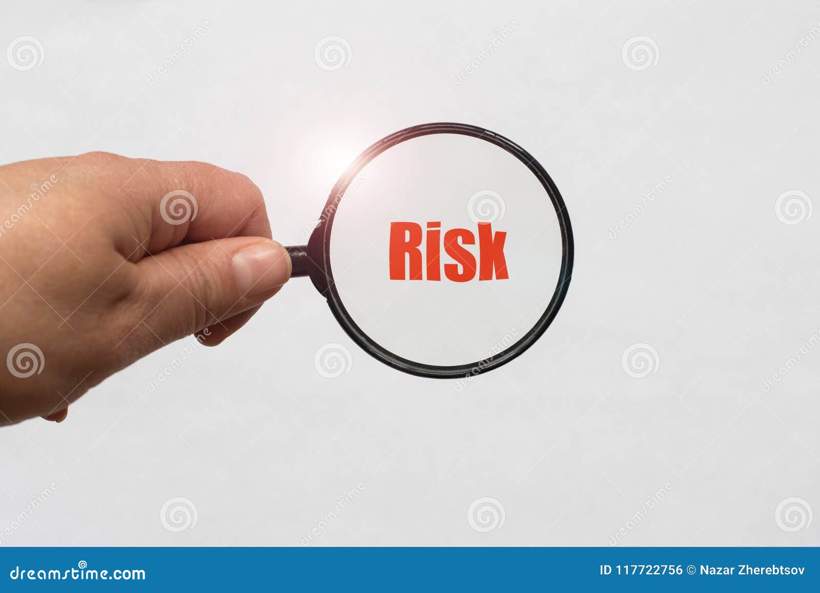 Magnifying Glass in Hand and a Risk Word on the White Background Stock ...