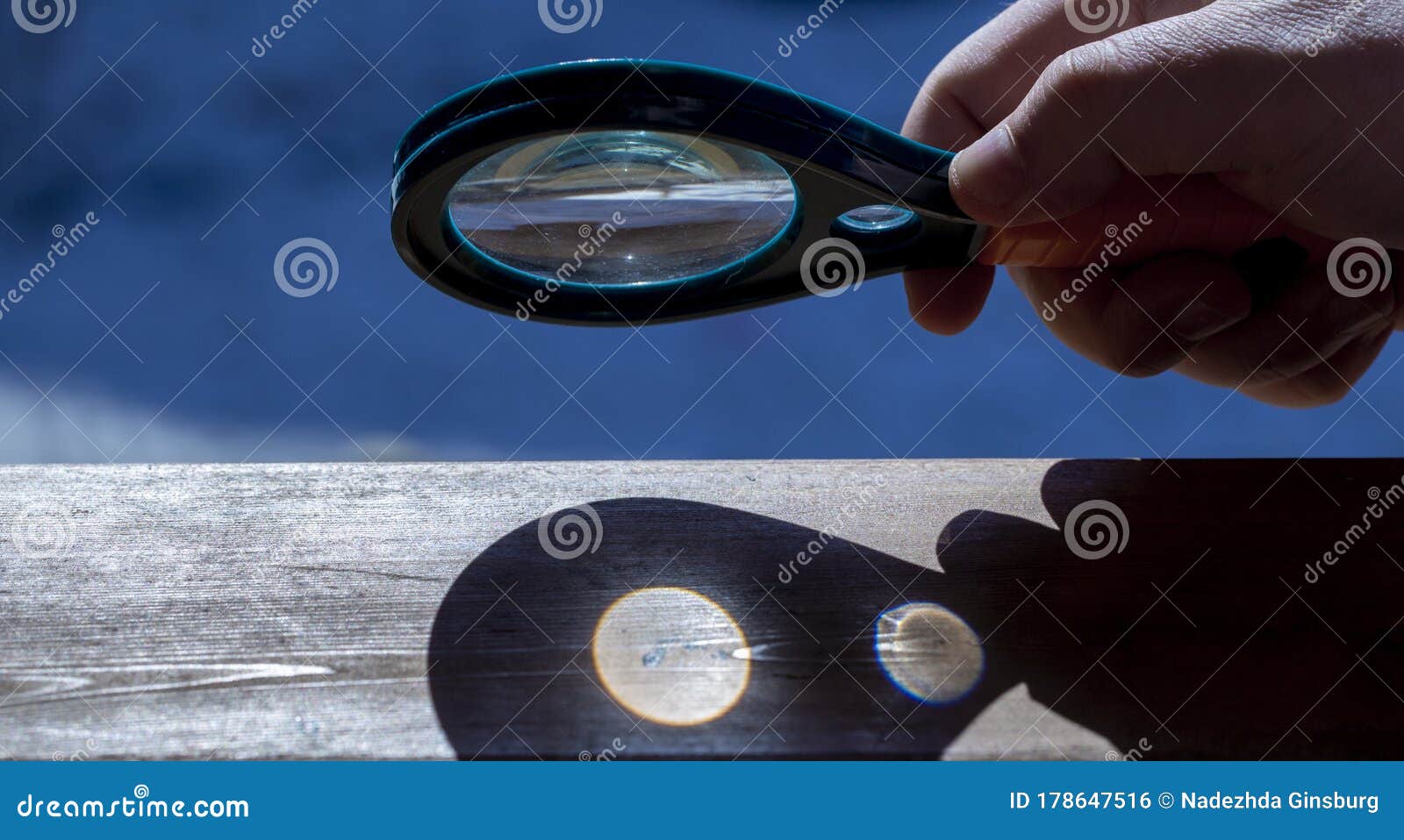 A Magnifying Glass in the Hands of a Man Who Teaches a Child To Make a ...