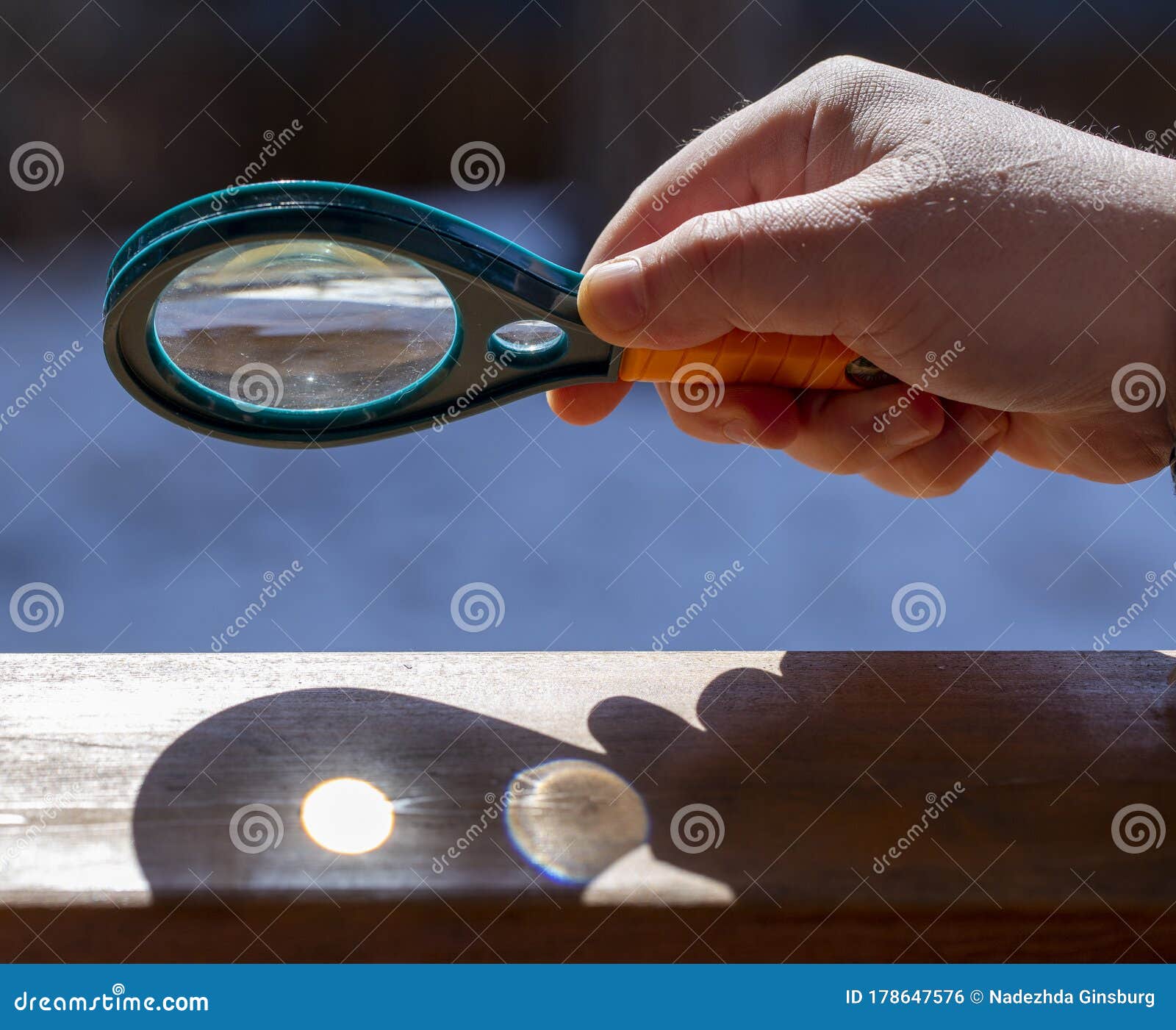 A Magnifying Glass in the Hands of a Man Who Teaches a Child To Make a ...