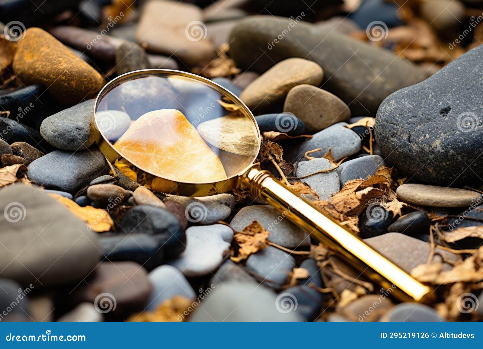 A Magnifying Glass Highlighting a Piece of Gold among Stones Stock ...