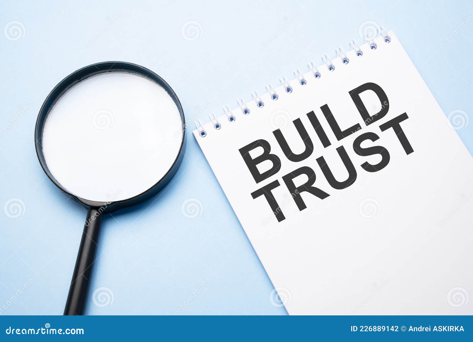 Magnifying Glass Loupe with Sign BUILD TRUST Blue Table Stock Photo ...