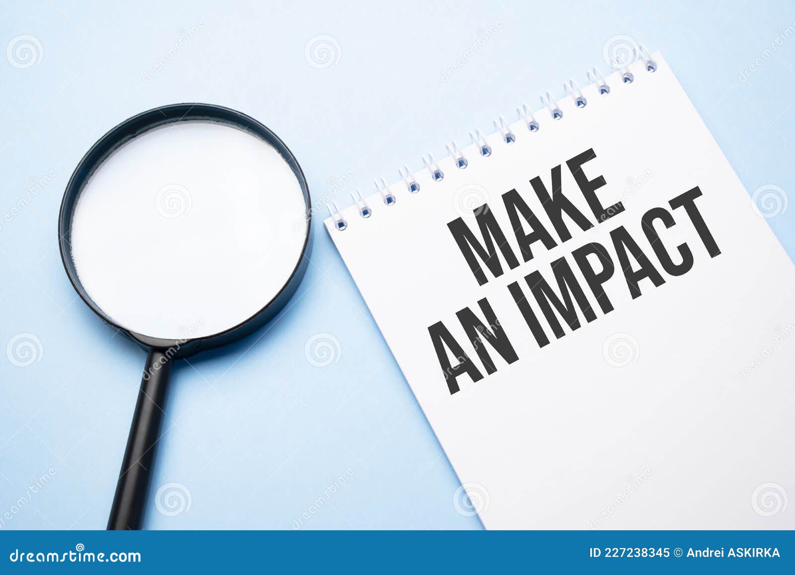 Magnifying Glass Loupe with Sign MAKE an IMPACT Blue Table Stock Image ...