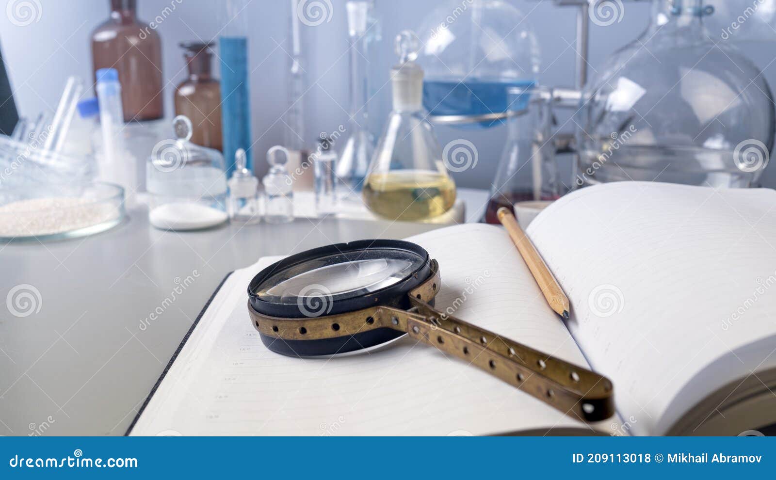 The Magnifying Glass is on the Notebook of the Table in the Laboratory ...