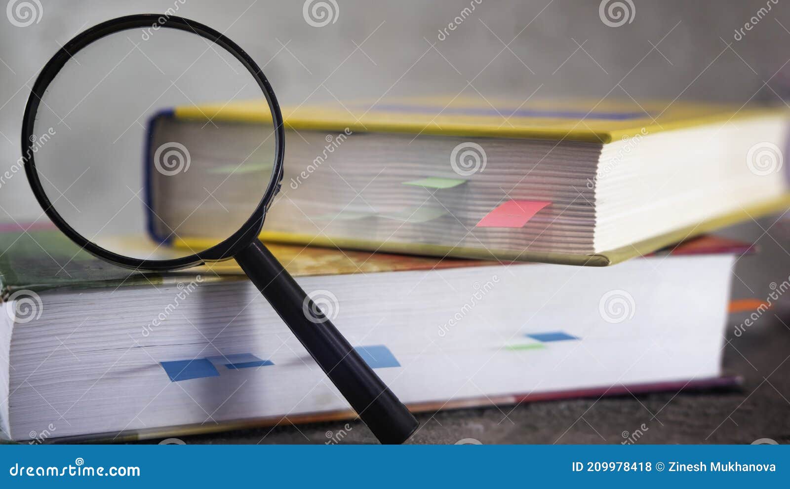 Magnifying Glass and an Open Book on a Table Stock Photo - Image of ...
