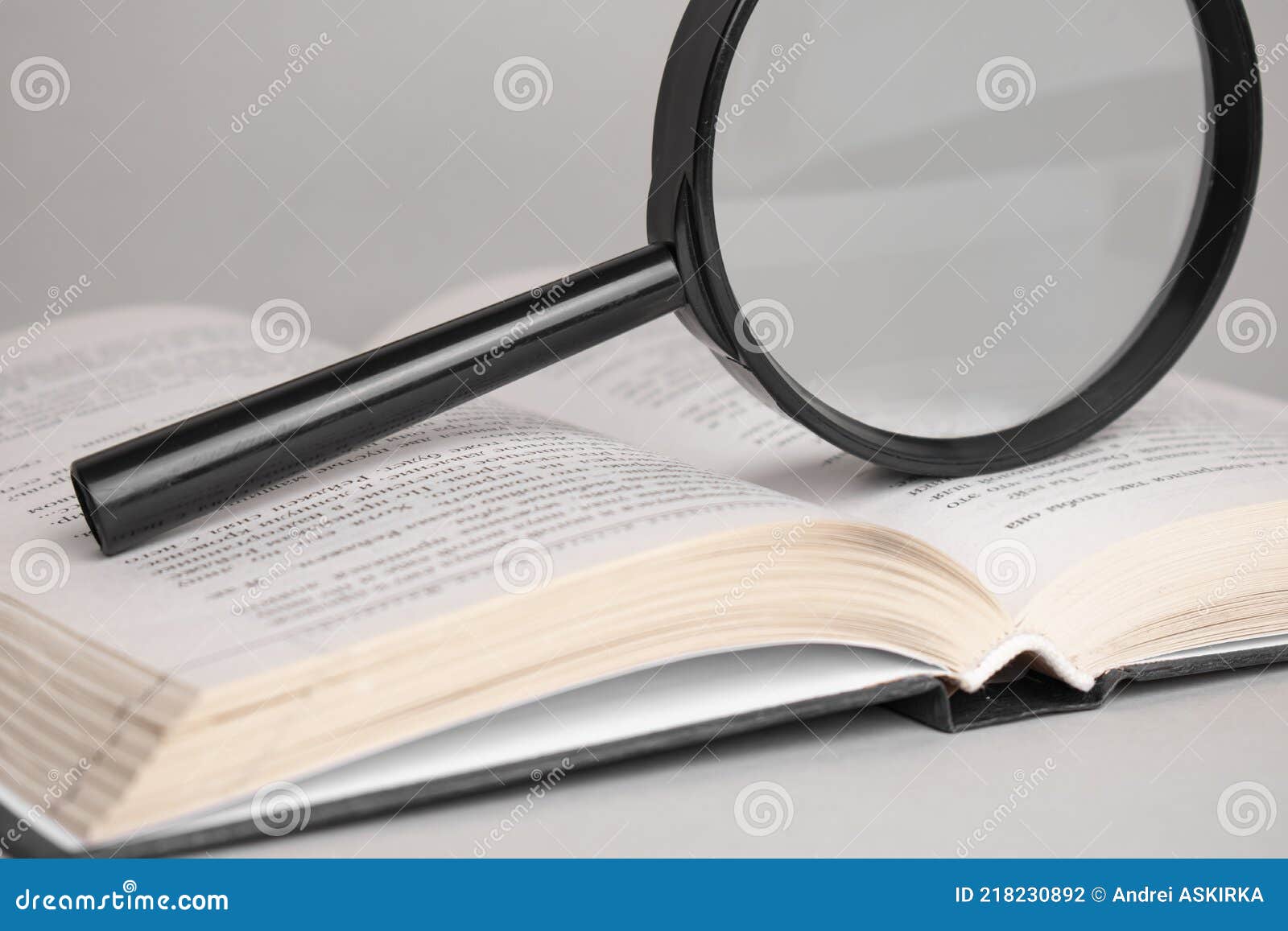 Magnifying Glass on Opened Old Book for Searching and Reading Concept ...