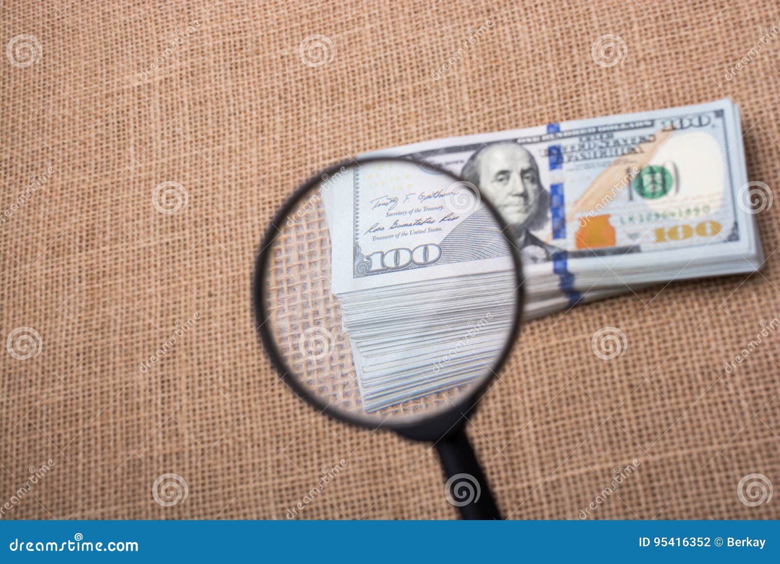 Magnifying Glass Over the Banknote Bundle of US Dollar Stock Photo ...