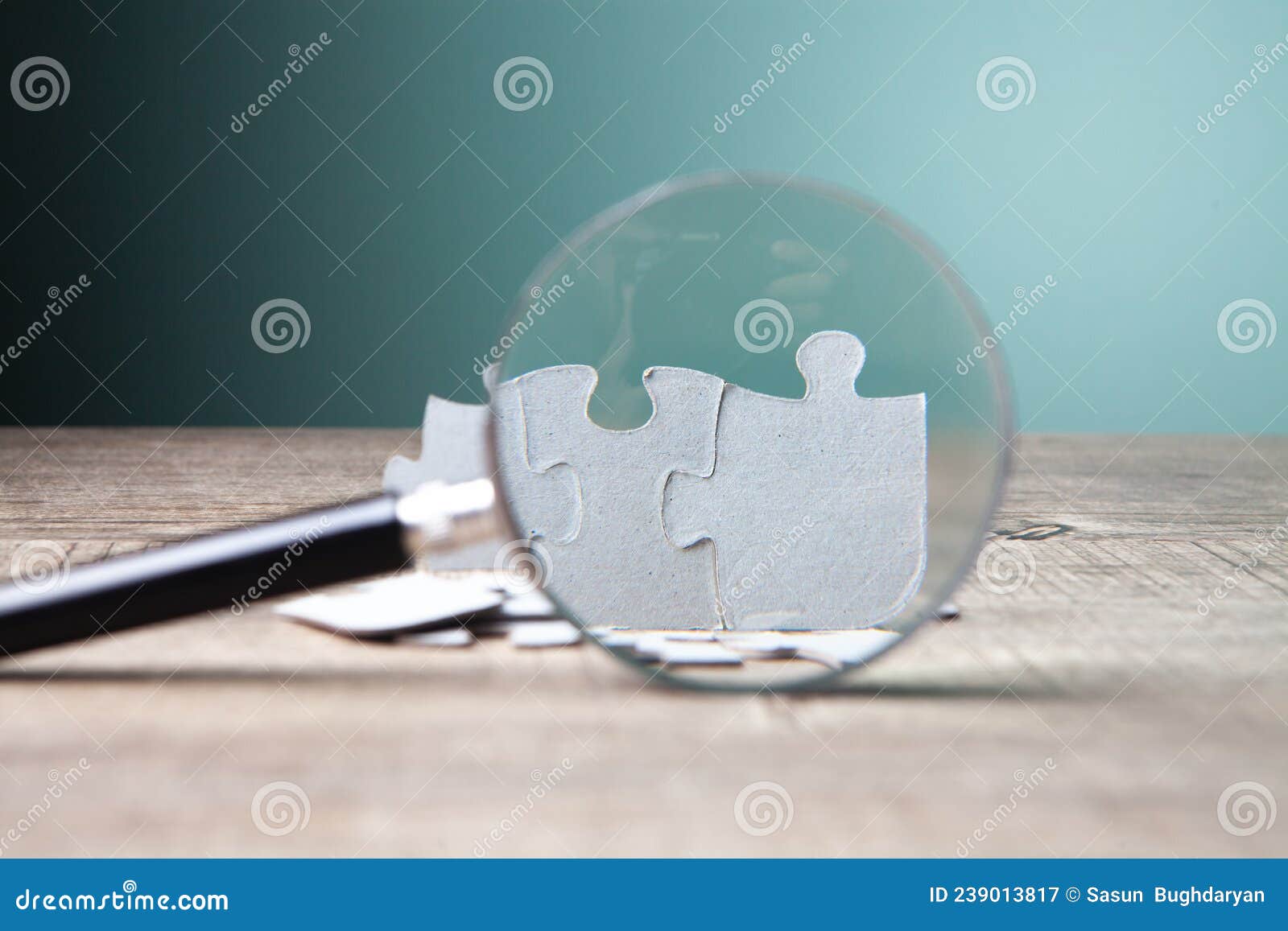 A Magnifying Glass and Puzzle Pieces on the Table Stock Image - Image ...