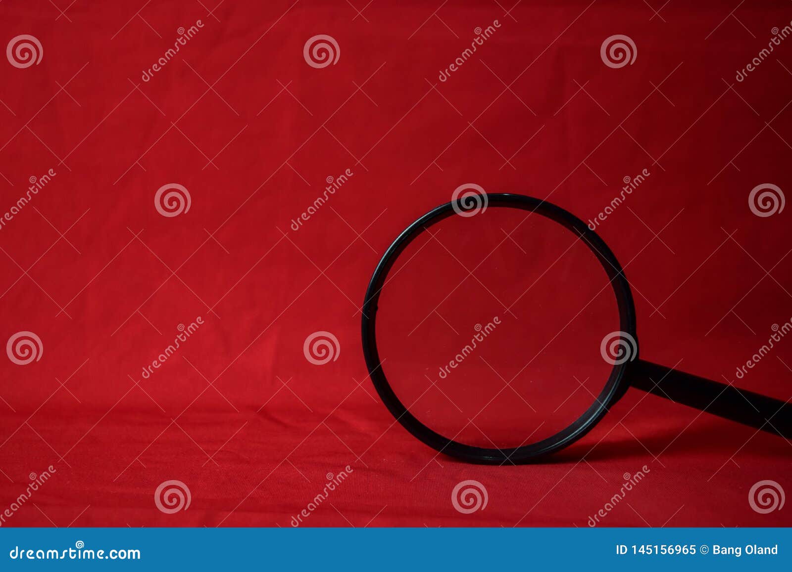 Black Magnifying Glass on Red Table Background Stock Image - Image of ...