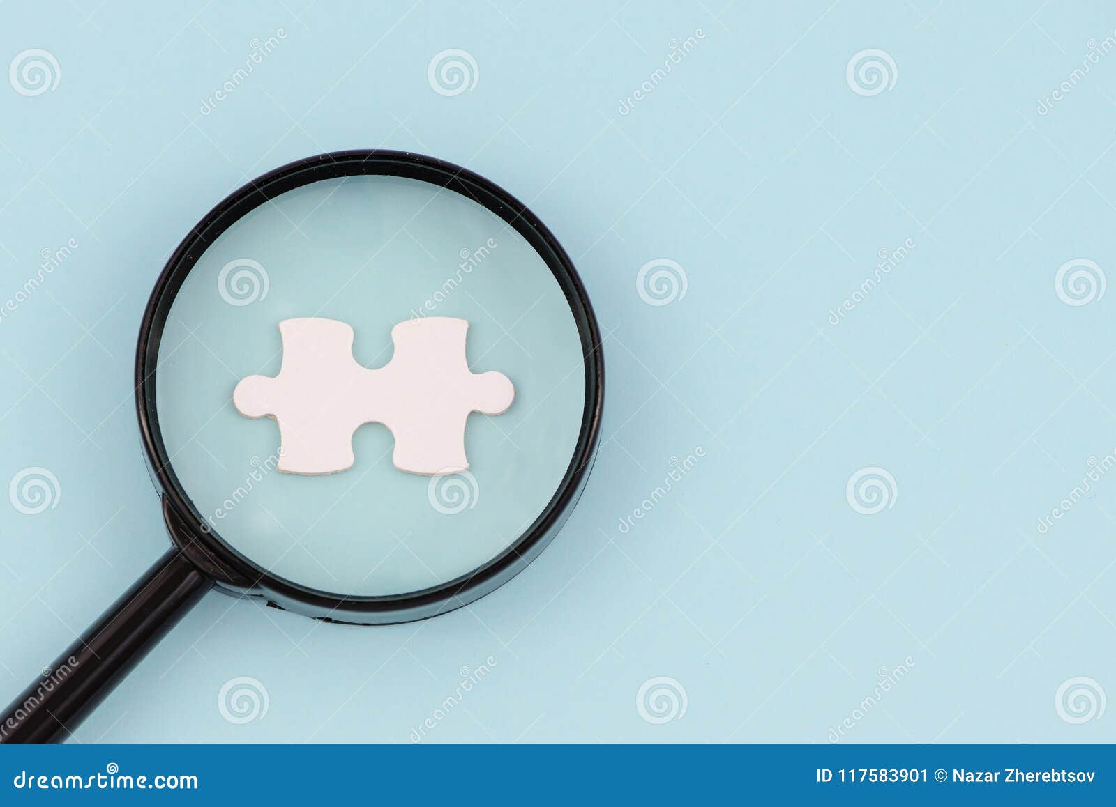 Magnifying Glass Searching for Missing Puzzle Pieces on Light Blue ...