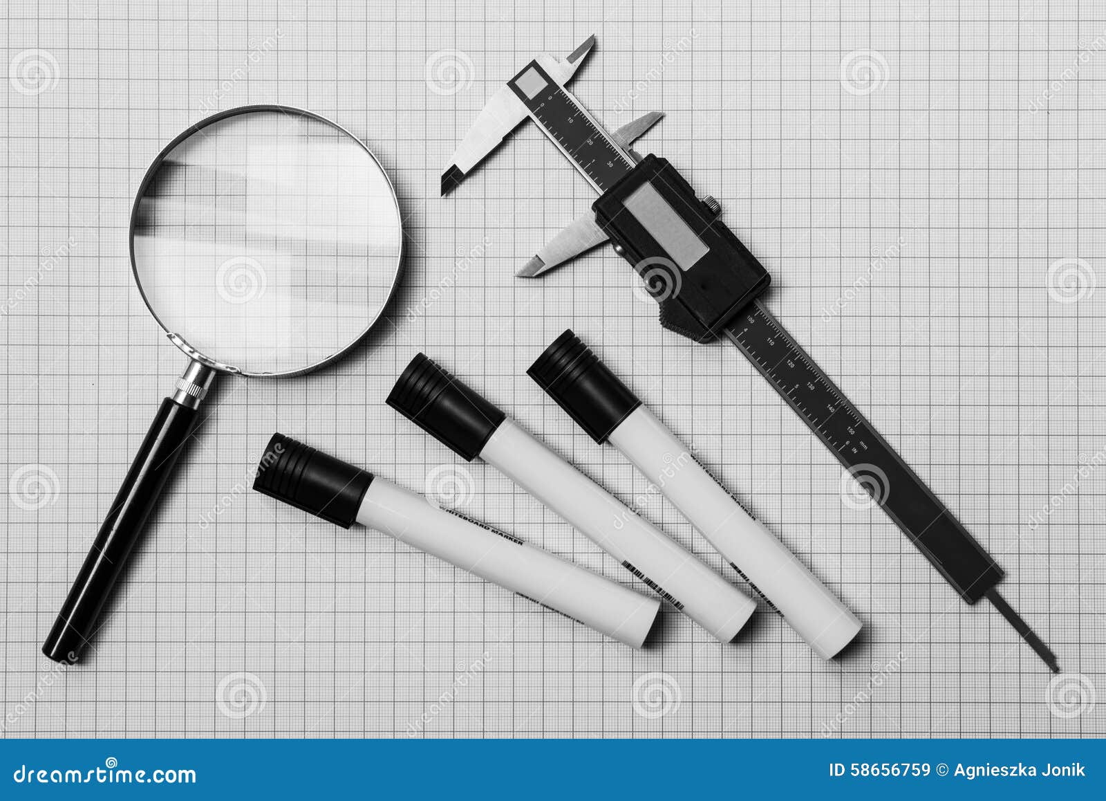 Magnifying Glass, Slide Calipers and Pens on a Graph Paper Stock Image ...
