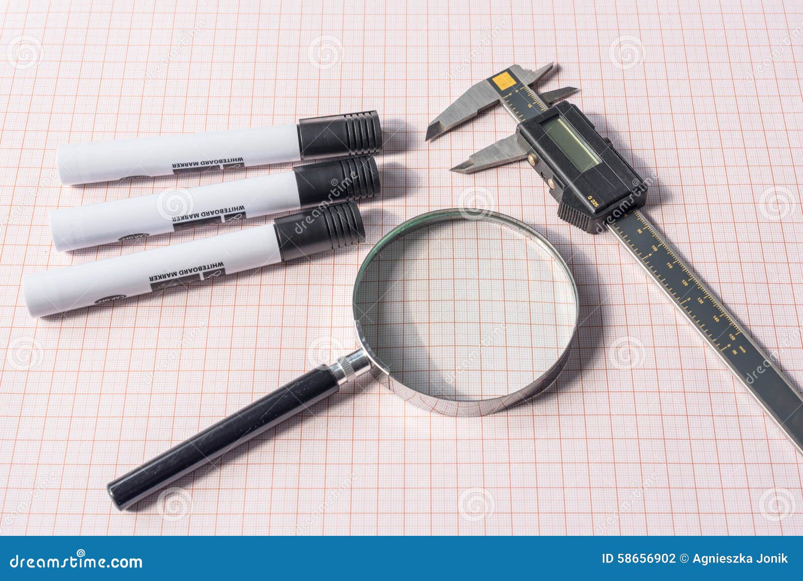 Magnifying Glass, Slide Calliper and Pens on a Graph Paper Stock Photo ...