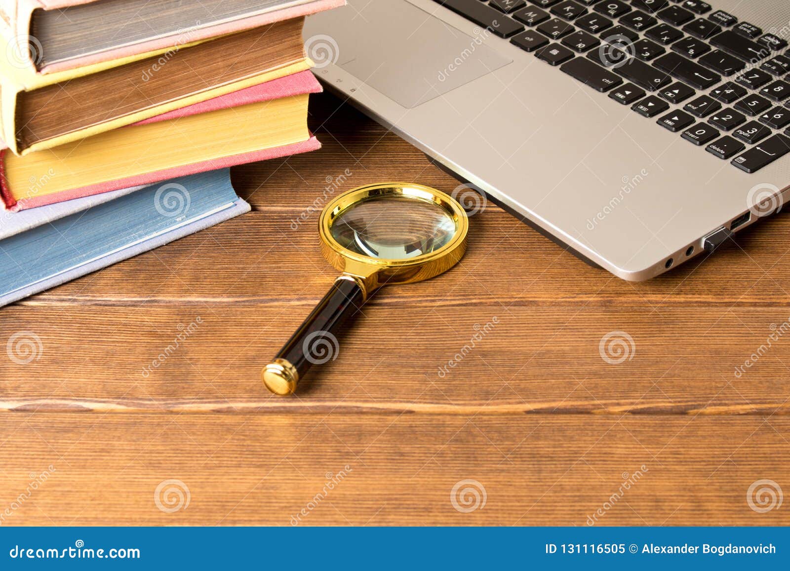 Magnifying Glass and a Stack of Books on the Laptop Keyboard. Th Stock ...
