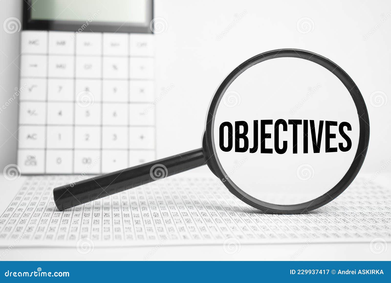 Magnifying Glass with Text Objectives on White Table with Calculator ...