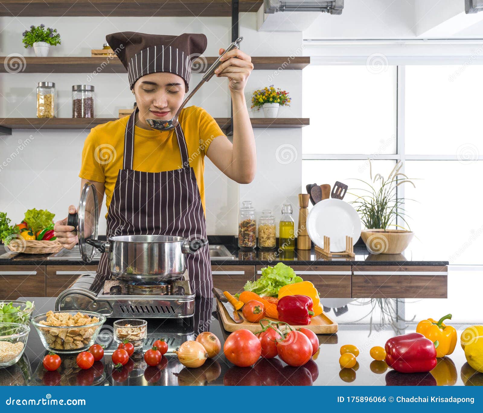 The Maid is Doing the Meat Stew in a Modern Kitchen Stock Photo - Image ...