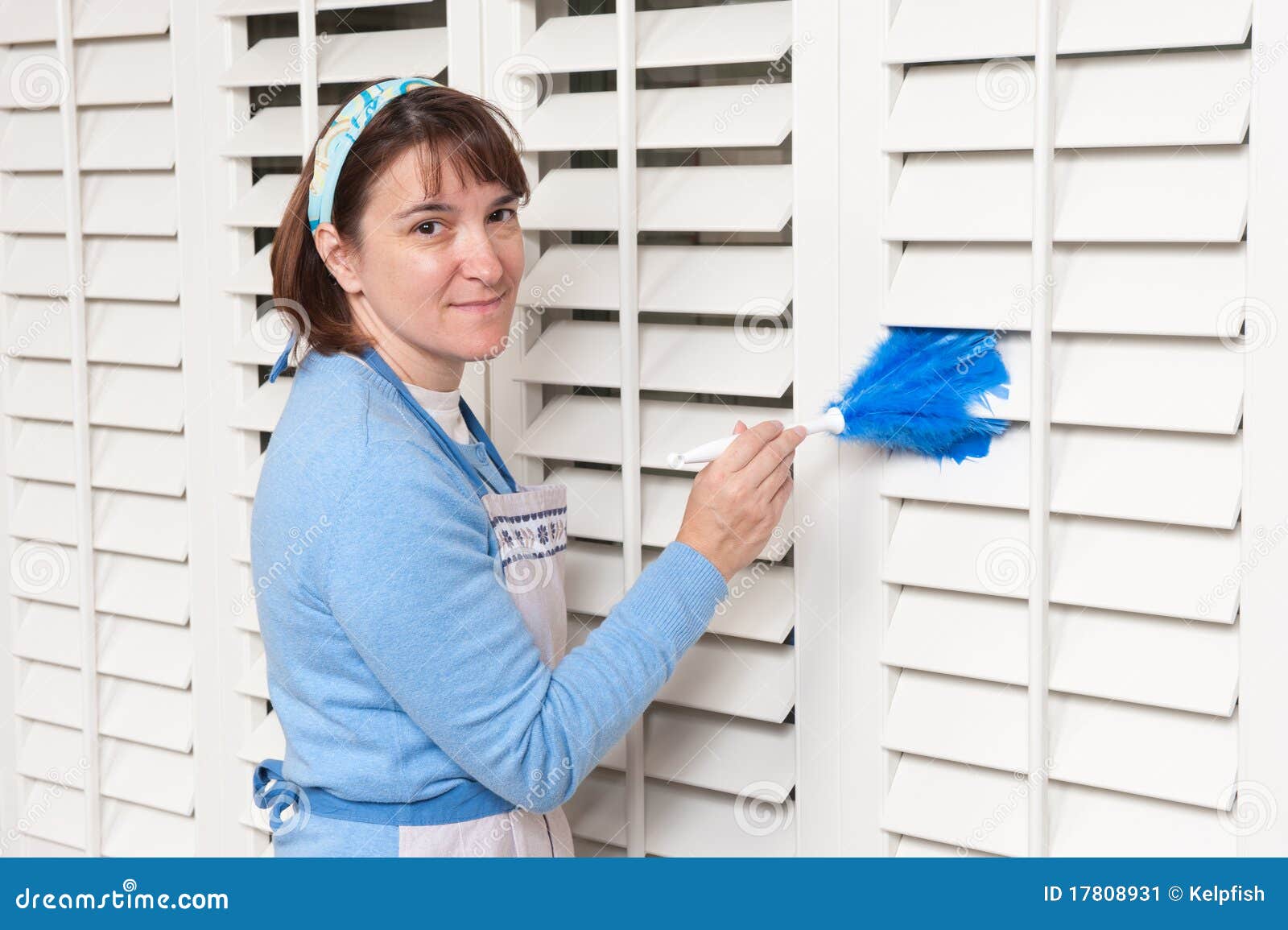 Maid dusting shutters stock image. Image of isolated - 17808931