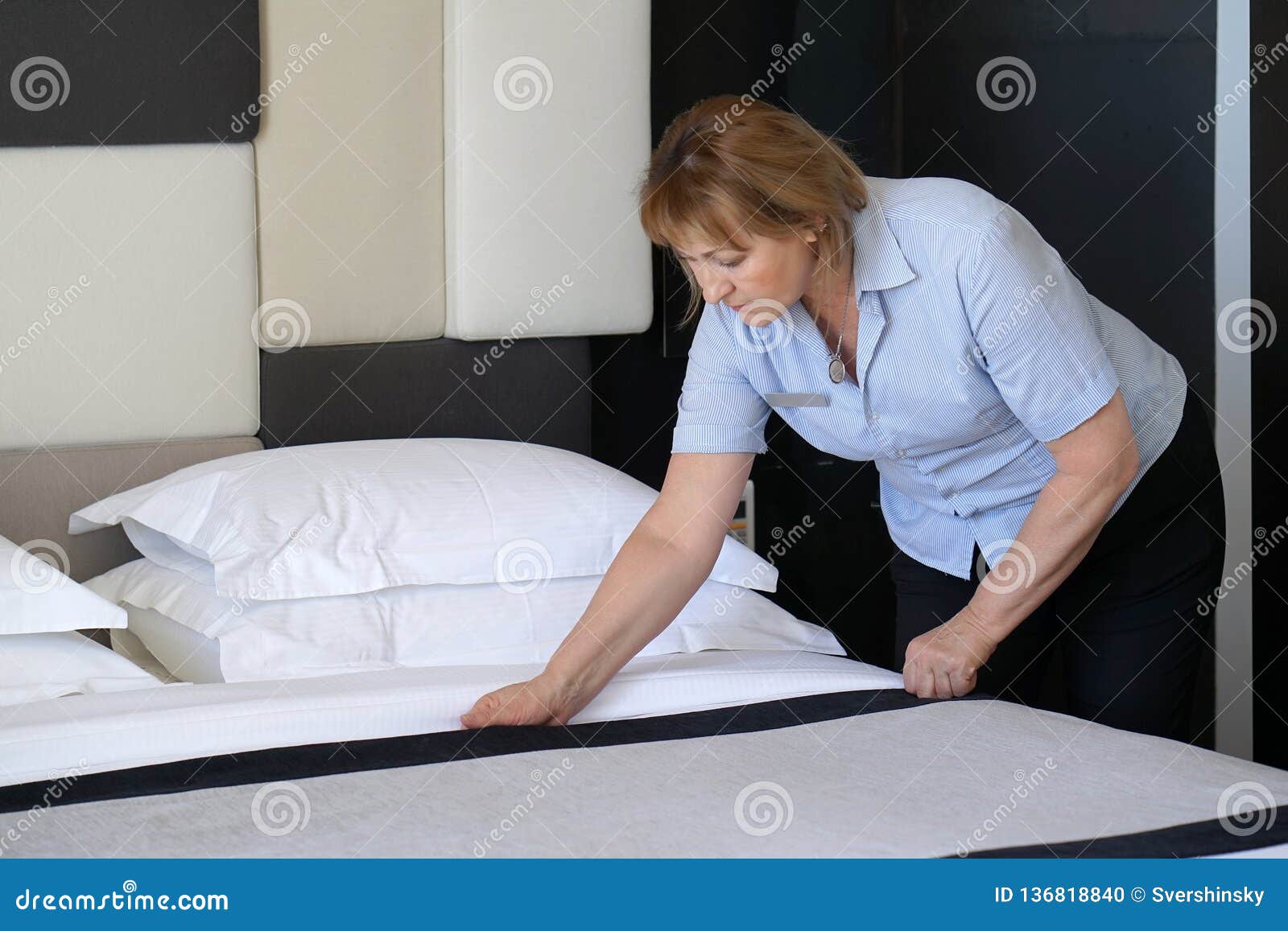 Maid Making Bed stock photo. Image of employee, interior - 136818840