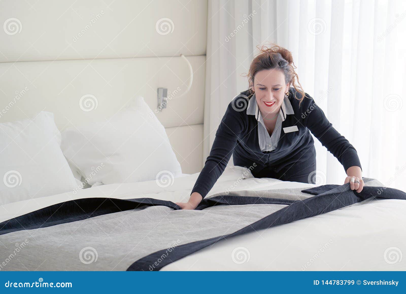Maid Making Bed stock image. Image of housekeeper, female - 144783799
