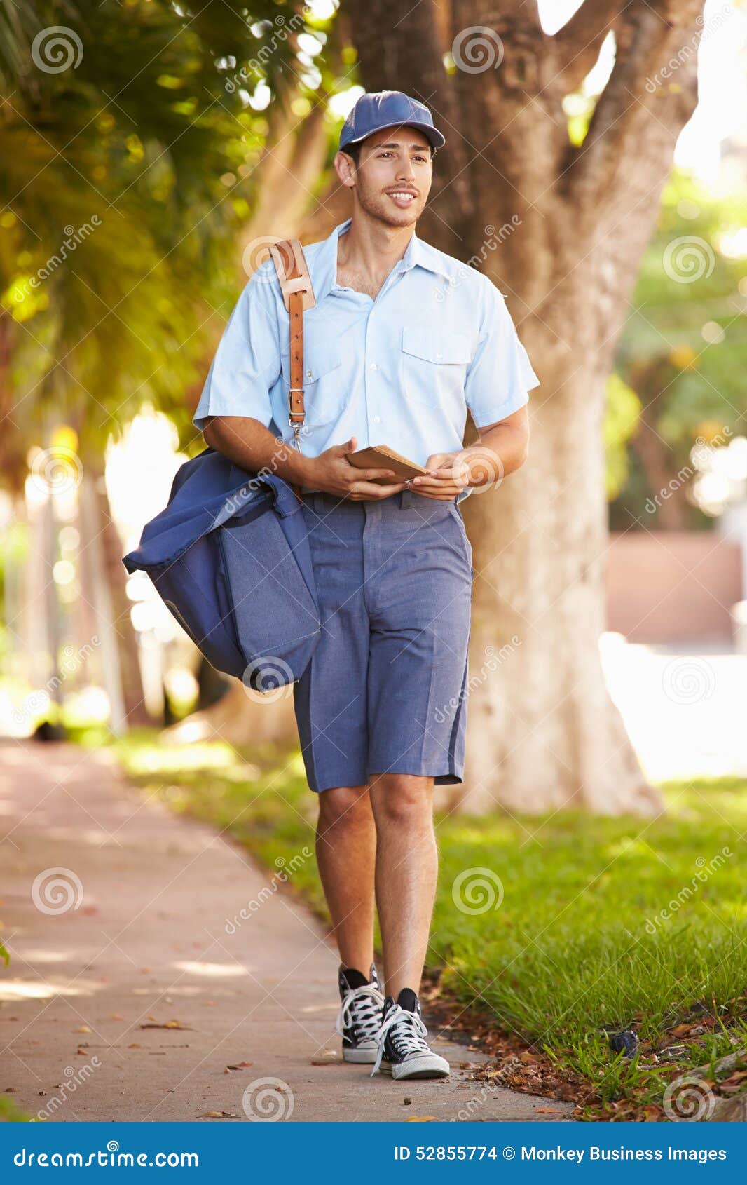 Mailman Walking Along Street Delivering Letters Stock Photo - Image of ...
