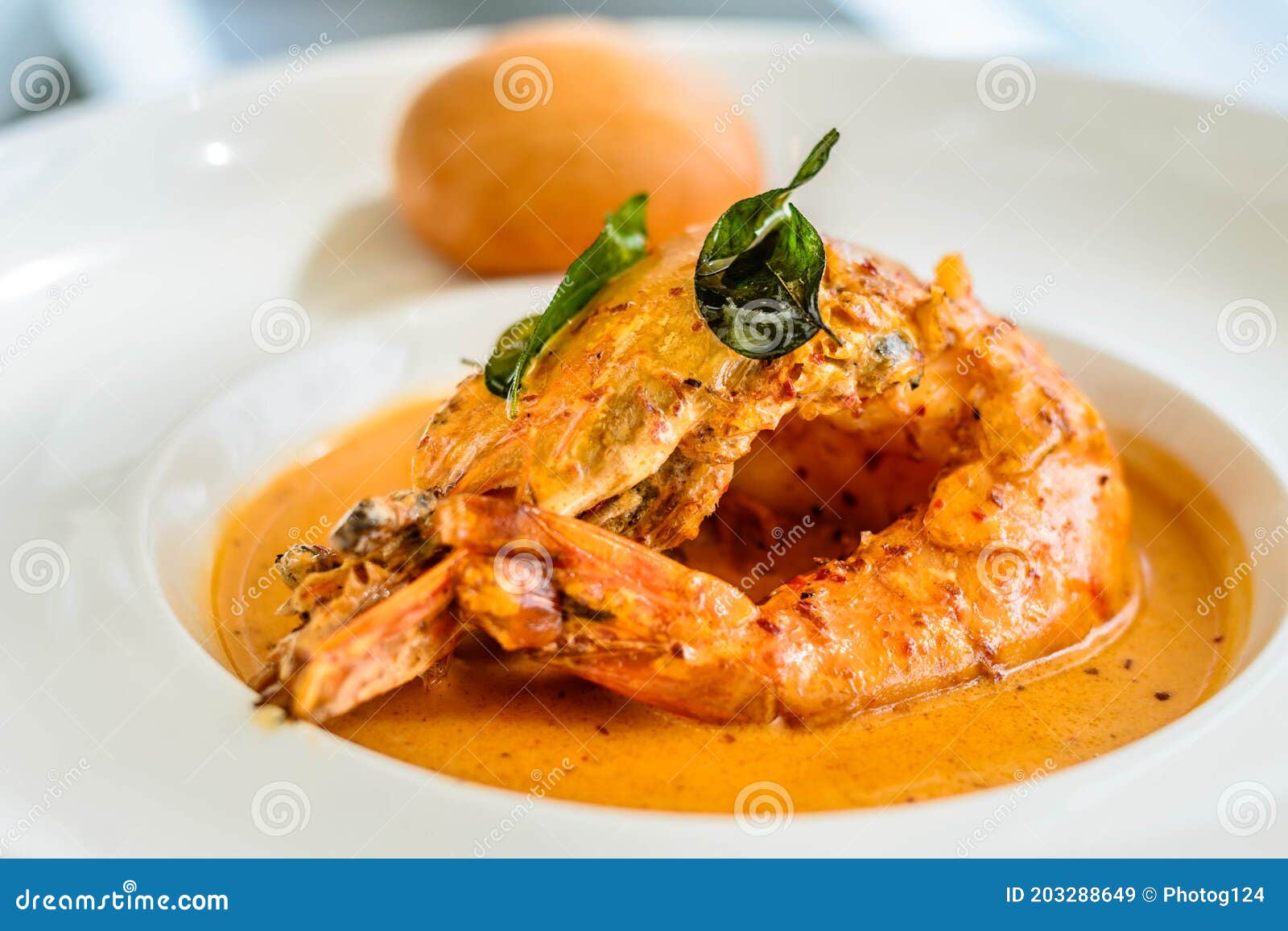 A Main Course of King Prawn Served in Bang Sauce with a Bun Stock Image ...