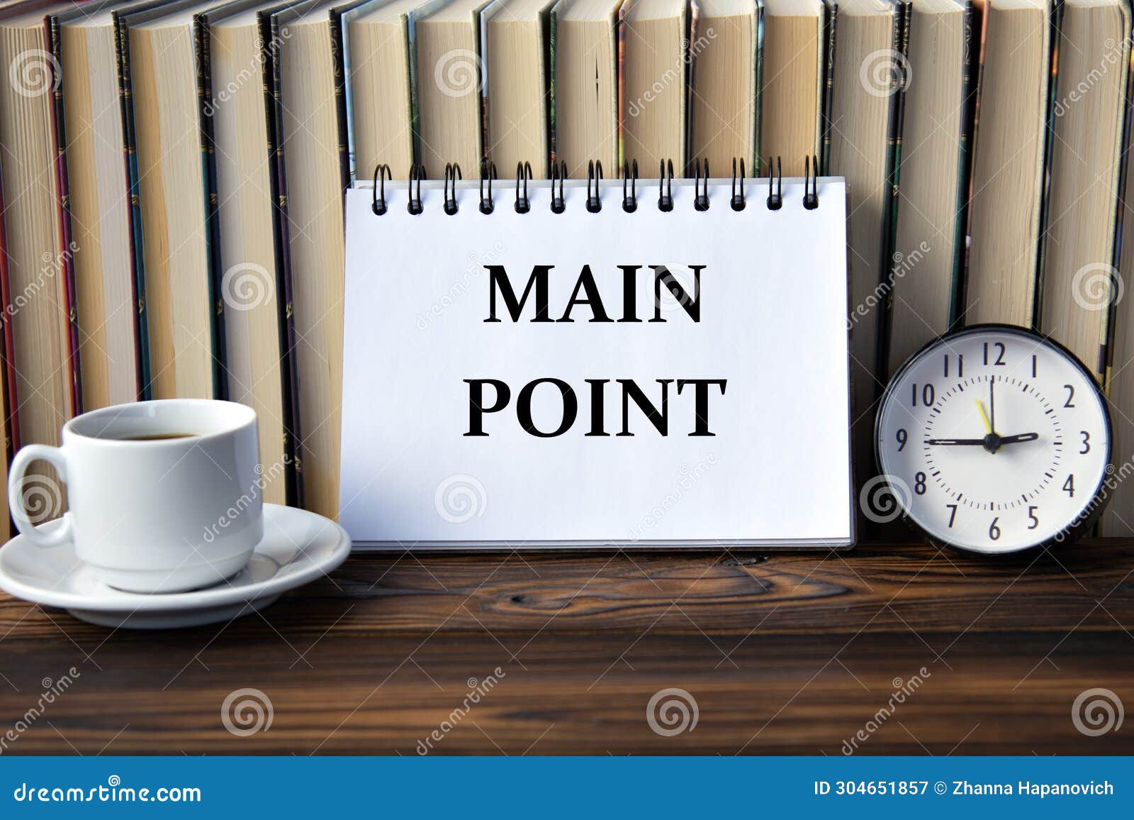 MAIN POINT - Words on White Notebook on Background of Books, Clock and ...