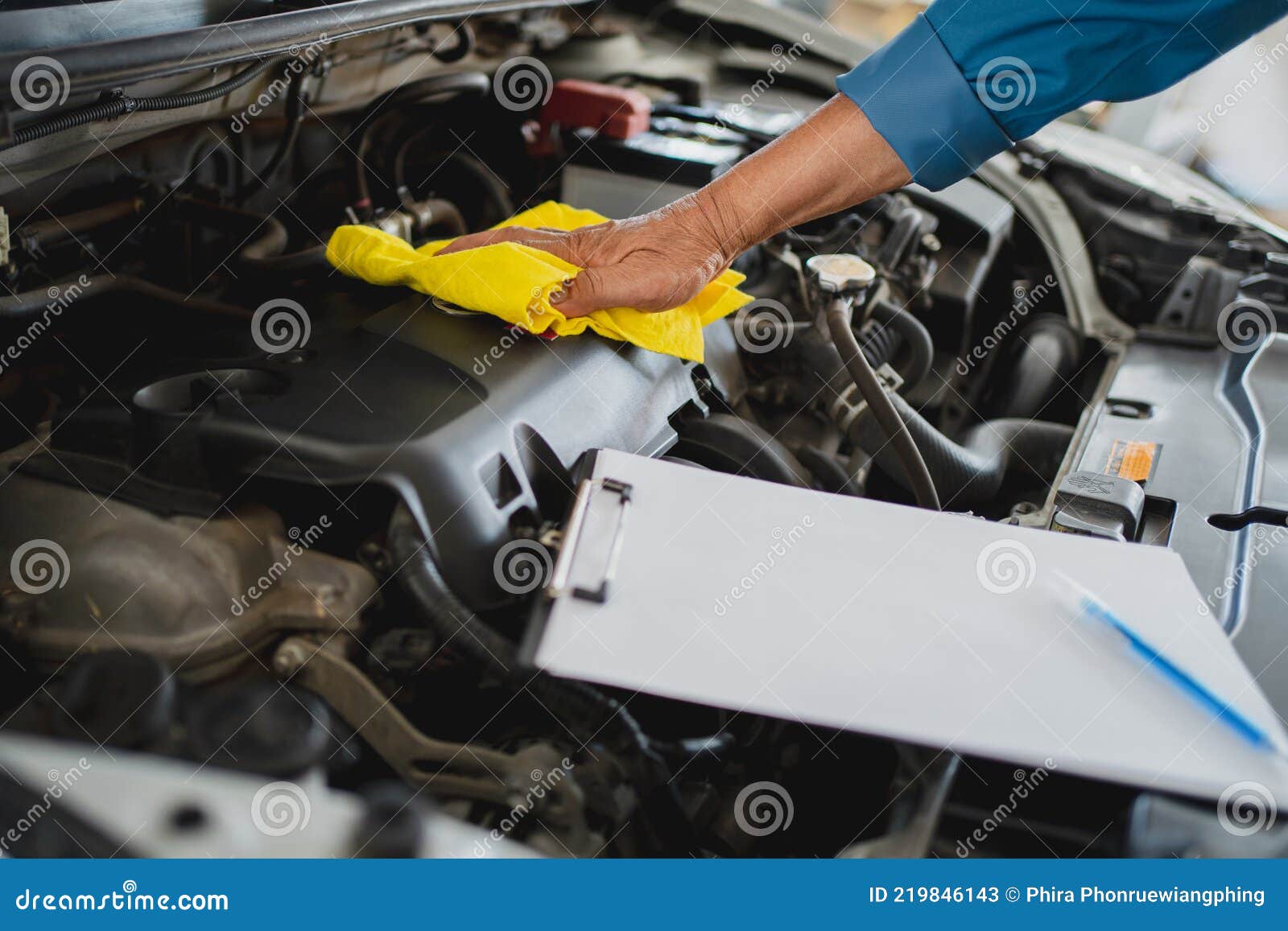 Maintenance Concept. Young Car Mechanic Cleaning the Engine in the ...
