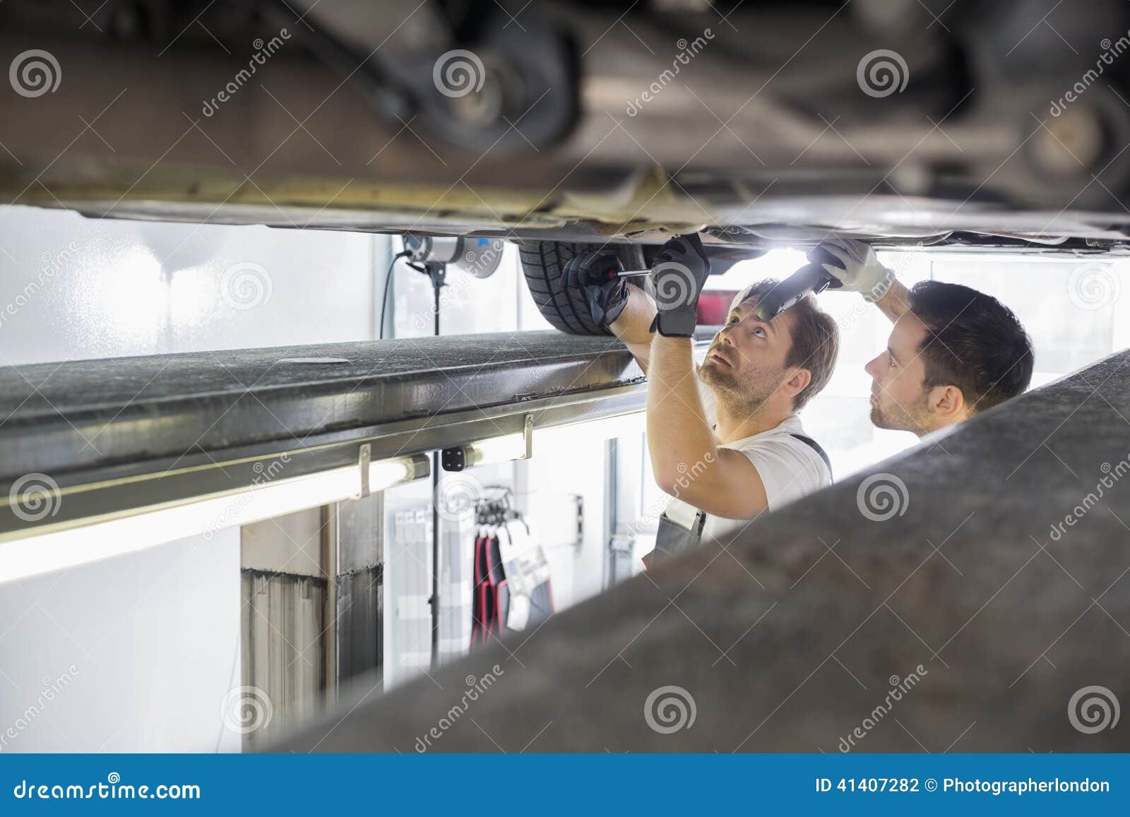 Maintenance Engineers Repairing Car in Workshop Stock Photo - Image of ...
