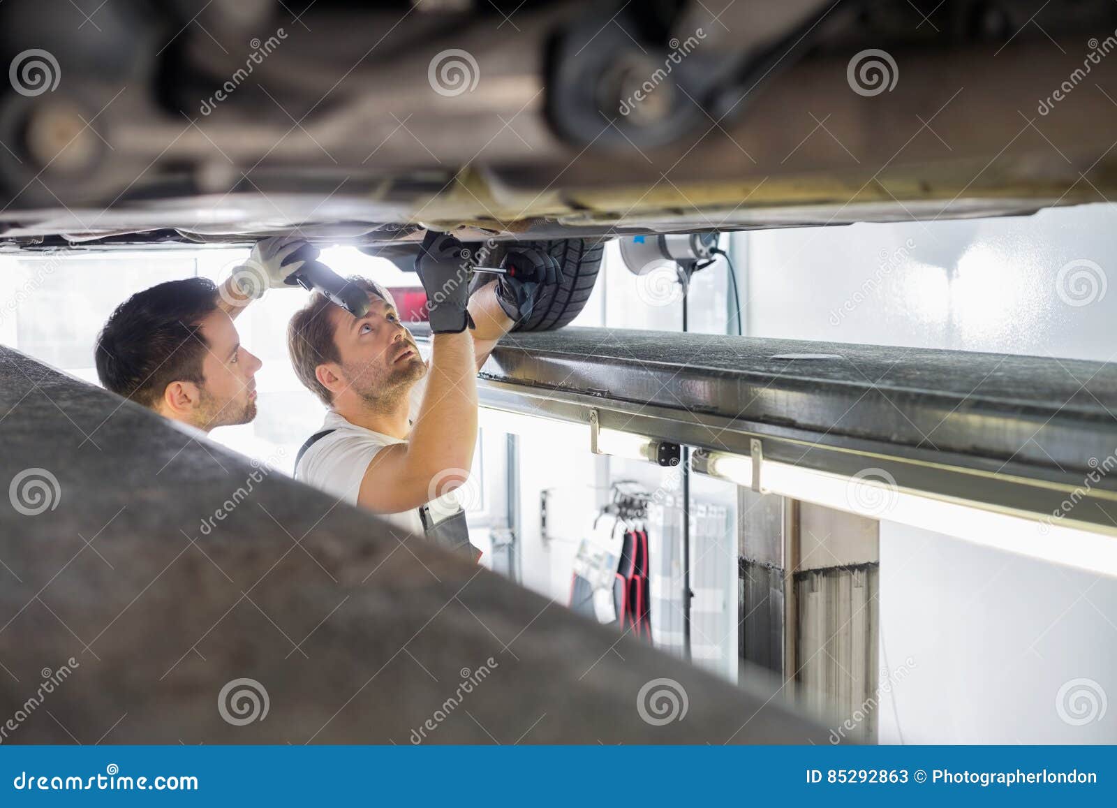 Maintenance Engineers Repairing Car in Workshop Stock Image - Image of ...
