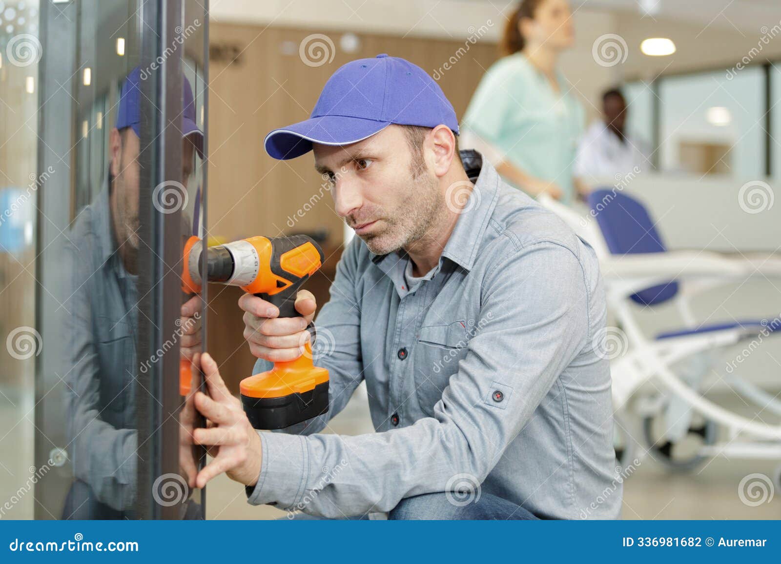 Maintenance Man Using Cordless Drill in Hospital Stock Photo - Image of ...