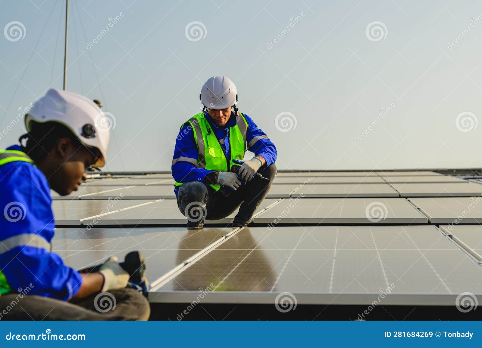 Maintenance Technicians Installing Solar Panels at Solar Cell Farm ...