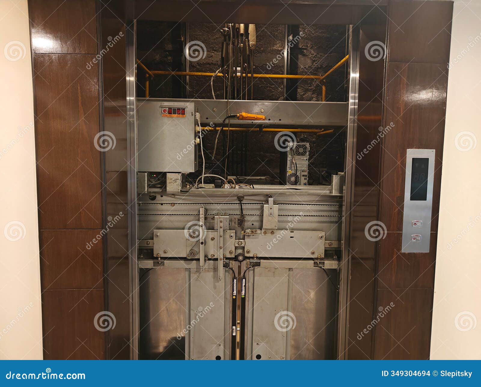Maintenance Work Reveals the Inner Machinery of a Sleek Elevator in a Contemporary Building ...