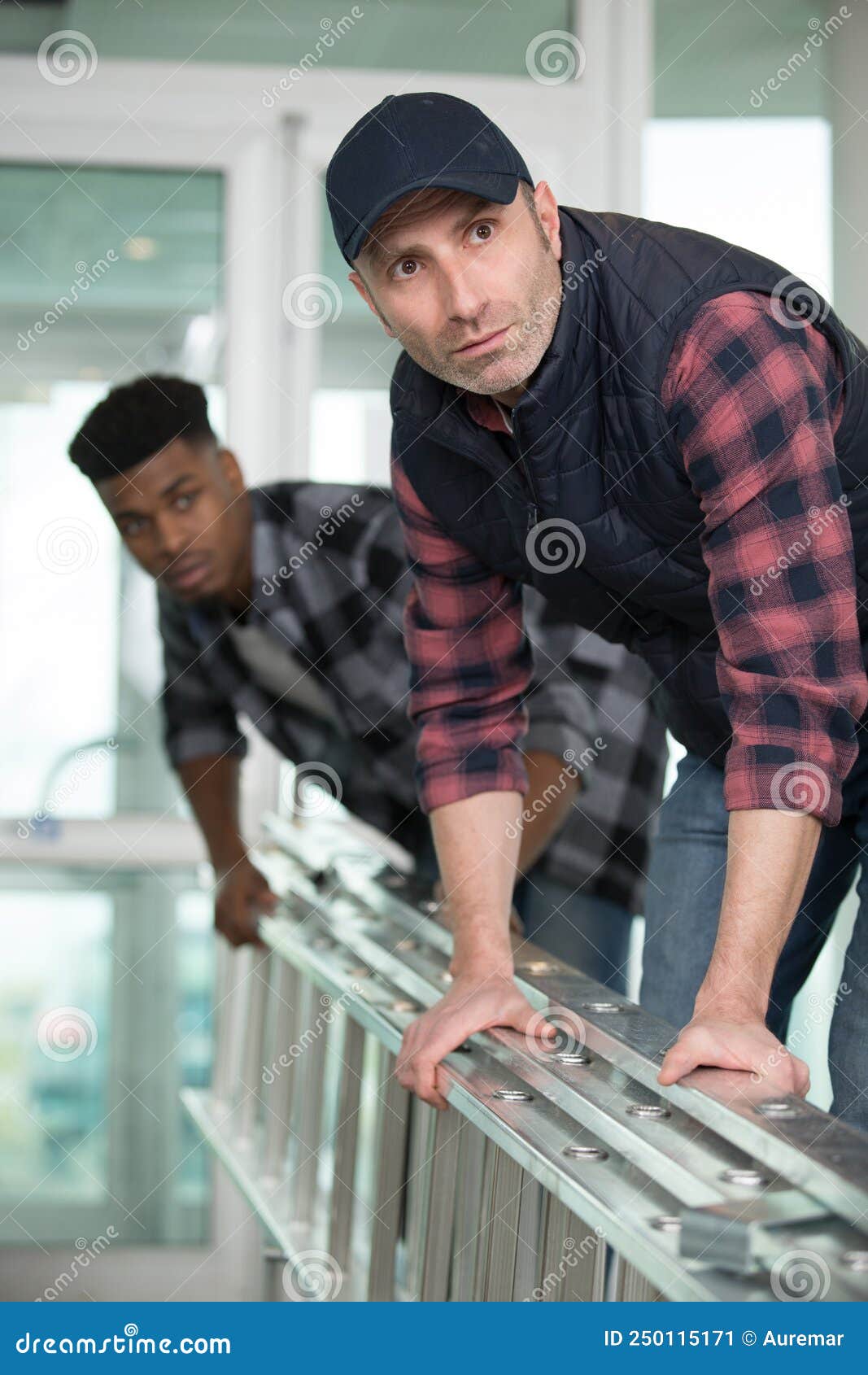 Maintenance Workers Carrying Aluminium Step Ladder at Construction Site ...