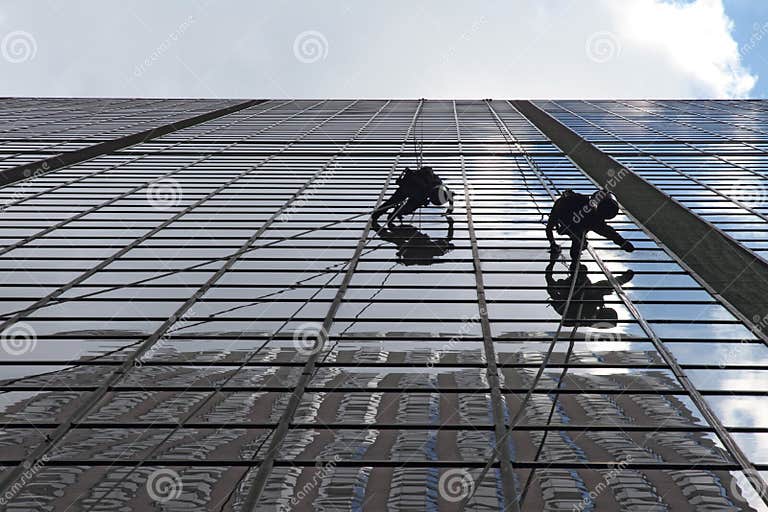 Maintenance Workers Climbing Outside a Skyscraper Stock Image - Image ...