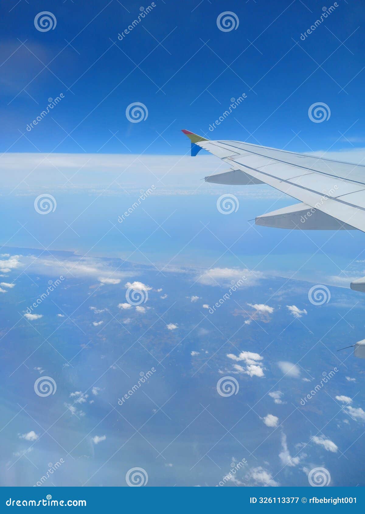 Majestic Airplane Wing in Flight Against a Backdrop of Billowy Clouds ...