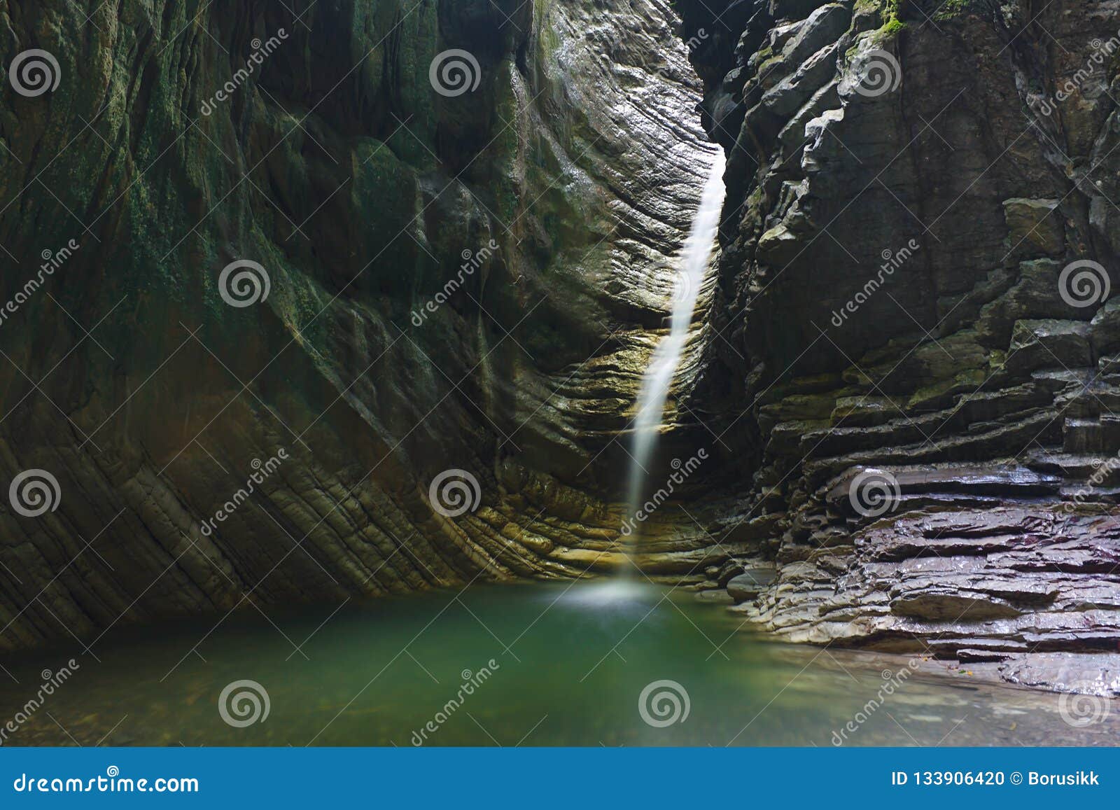 Majestic Deep Grotto with Pouring Refreshing Waterfall Stock Photo ...