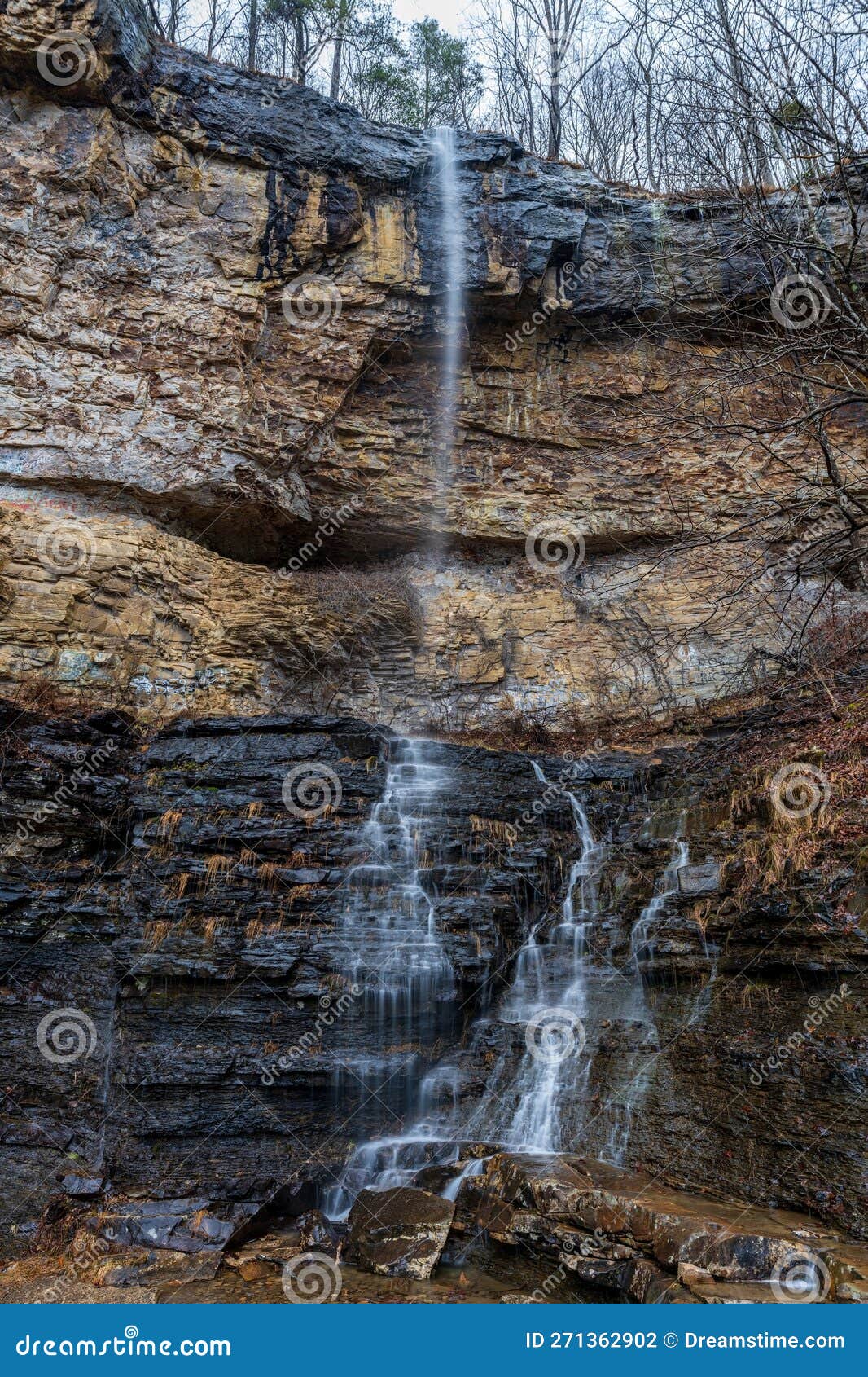 Majestic Waterfall Cascading Down a Sheer Rock Face into a Tranquil ...