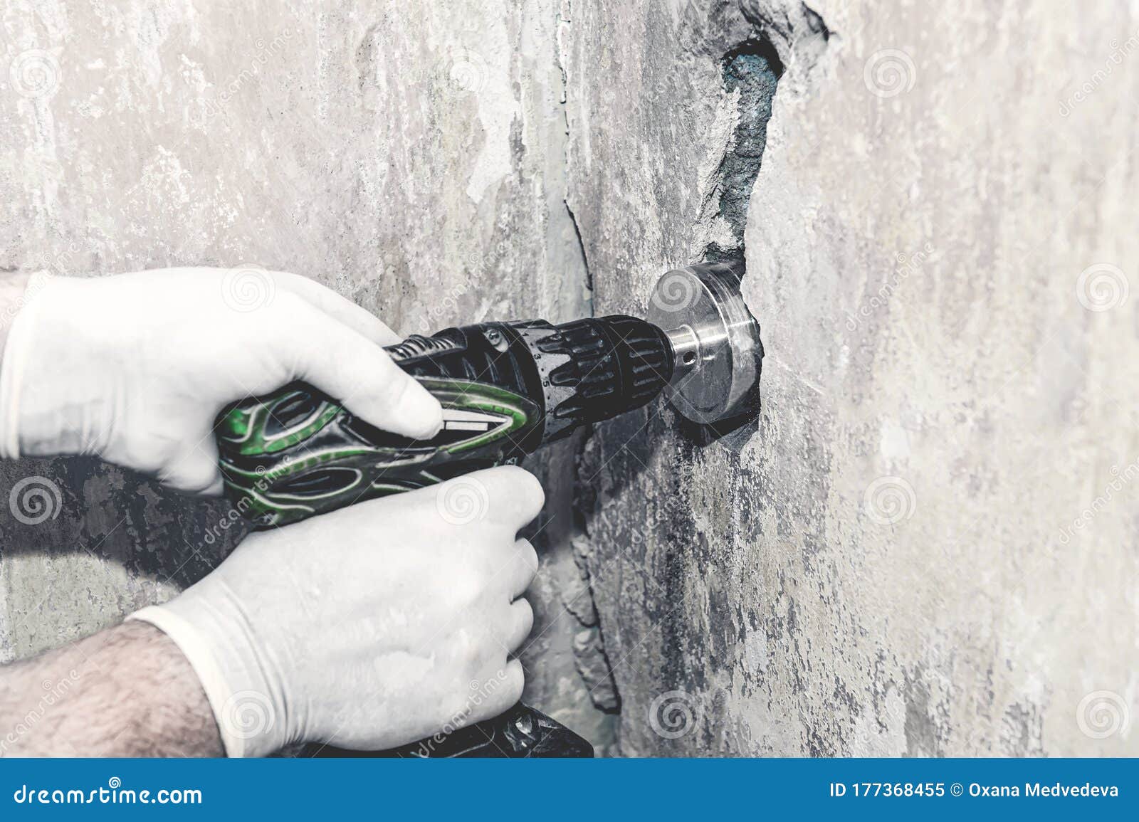 Make a Hole in the Wall for an Electrical Outlet. Master`s Hands with ...