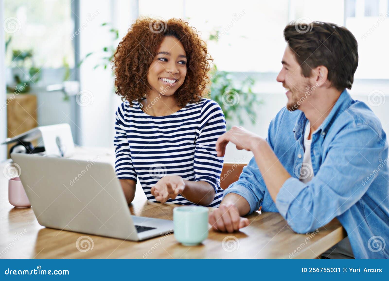 We Make Teamwork Work. Two Coworkers Working Together at Their Desks ...