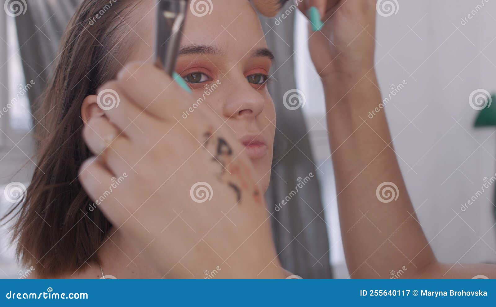 Make-up Artist Applying Makeup To Model S Face Close Up View. Stock ...