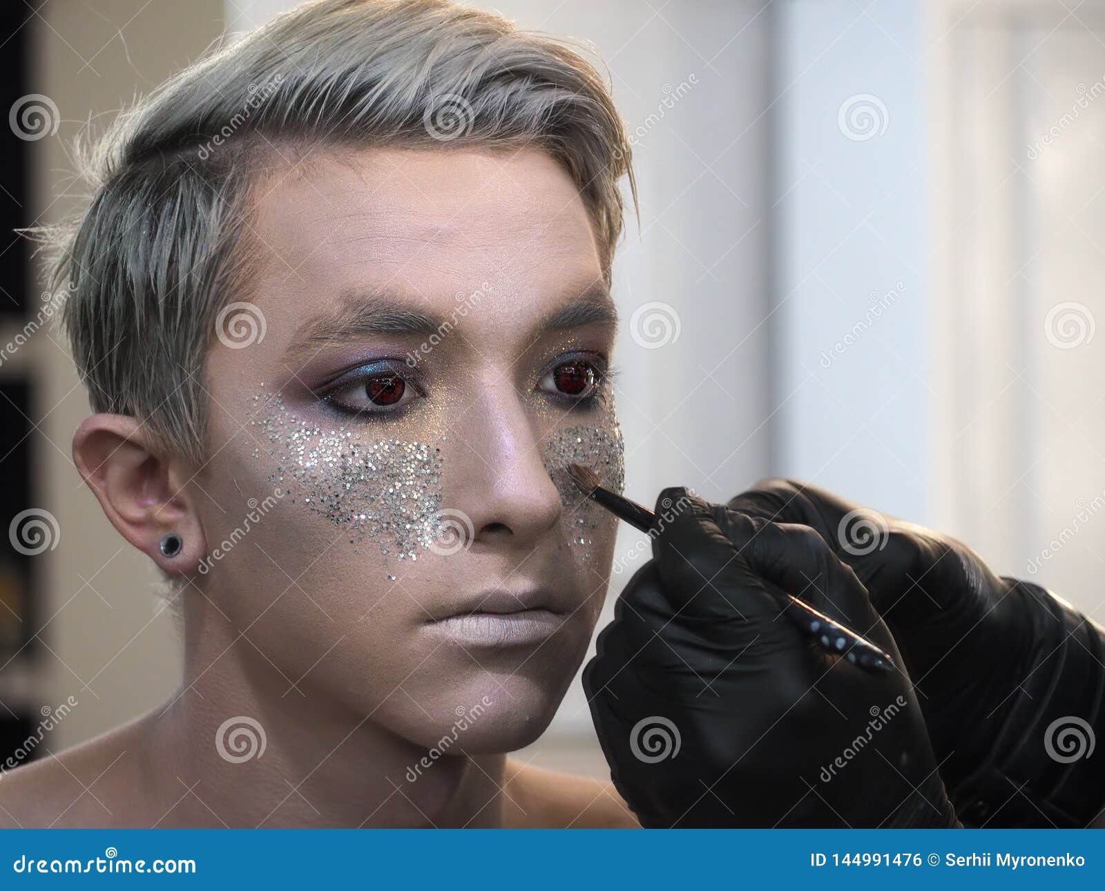 Make Up Artist Makes Make-up at the Young Male Model Like Caesar Stock ...