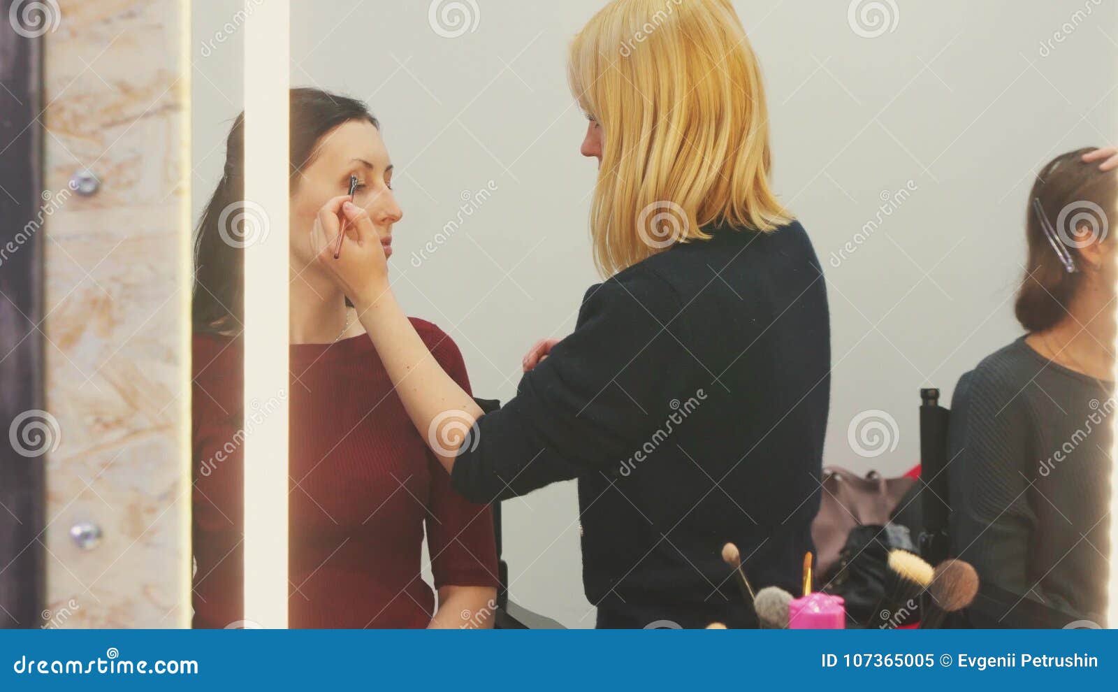 Make-up Artist at Work with the Model in the Mirror Reflection Stock ...